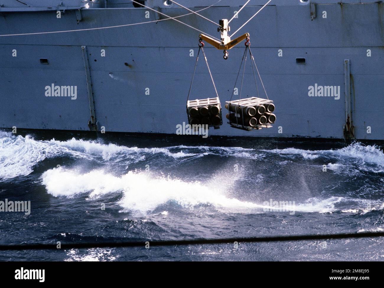 Two pallets of Mark 82 500-pound bombs travel on a wire highline ...