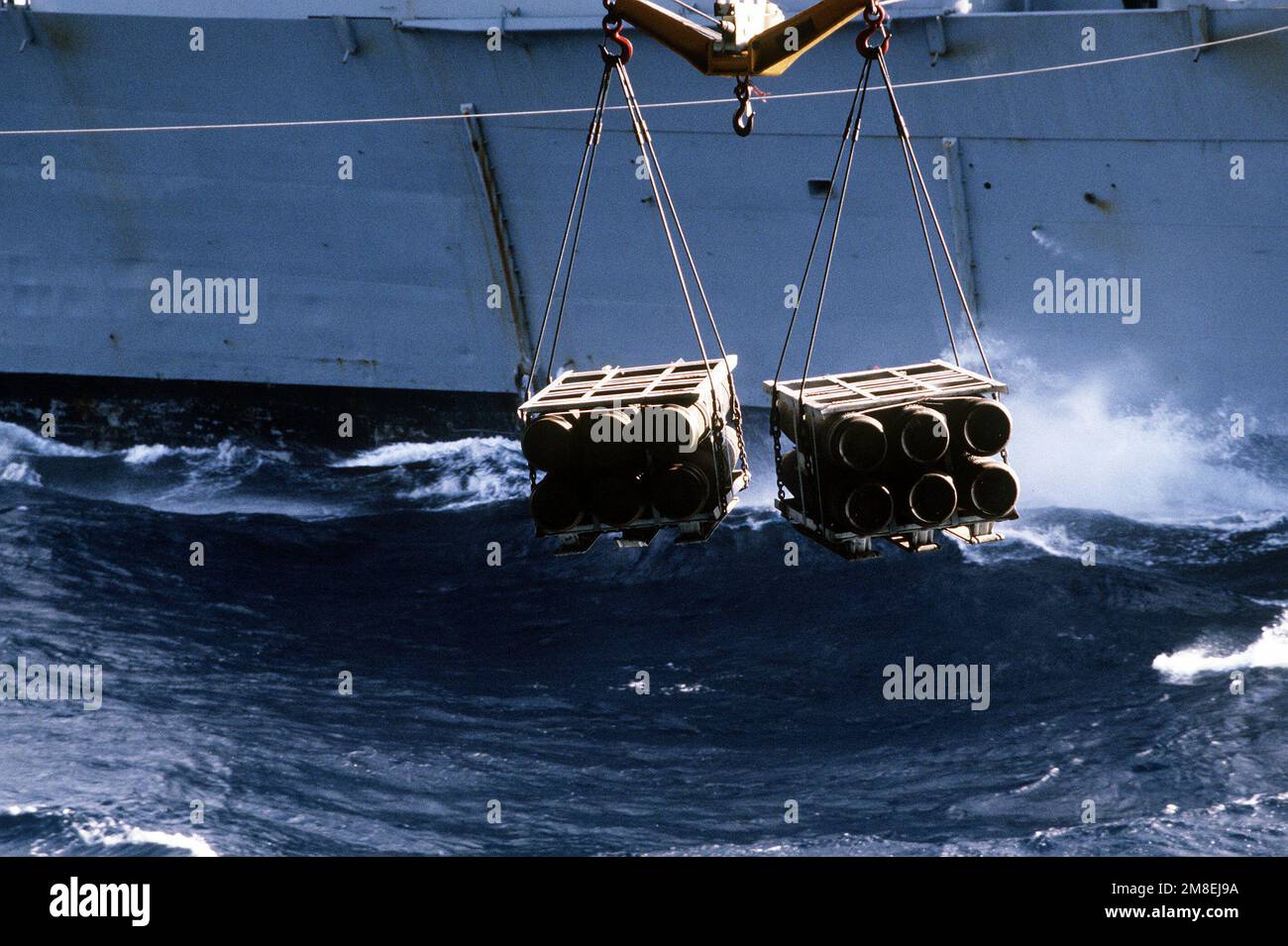 Two pallets of Mark 82 500-pound bombs travel on a wire highline ...
