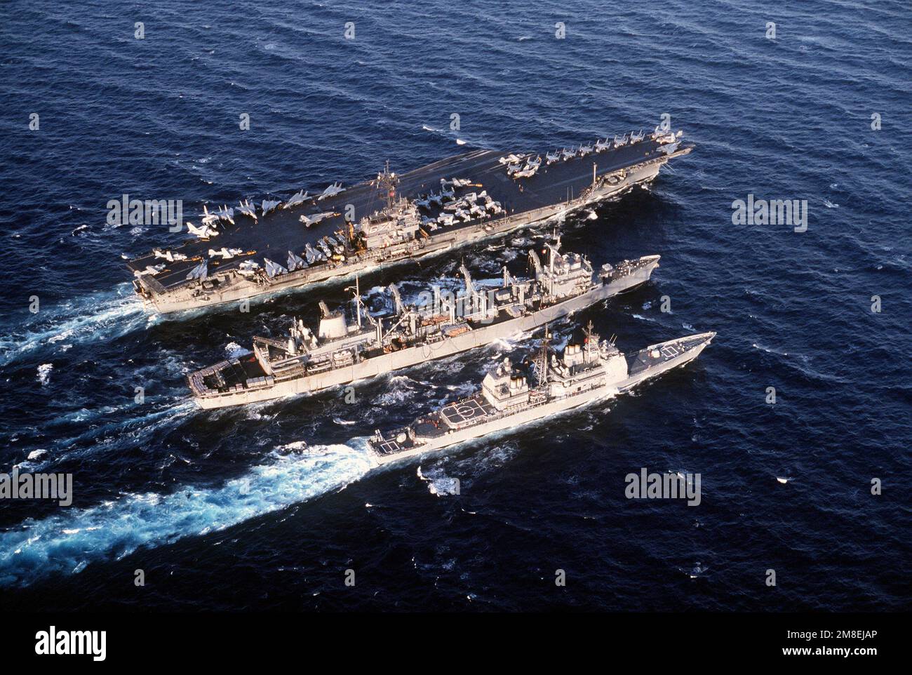 The fast combat support ship USS DETROIT (AOE-4), is flanked by the ...