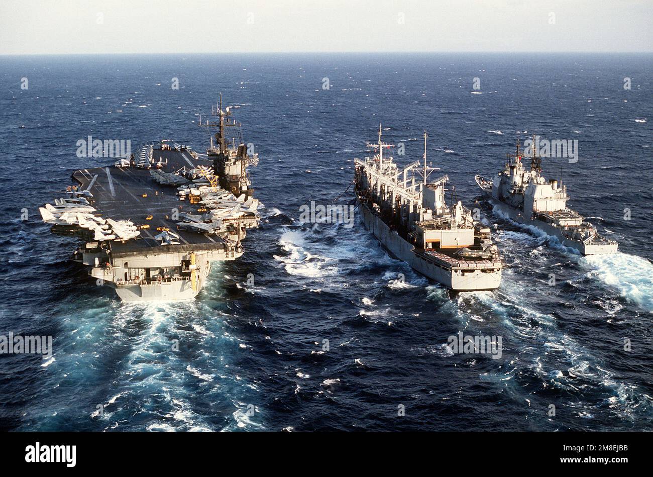 The fast combat support ship USS DETROIT (AOE-4) is flanked by the ...
