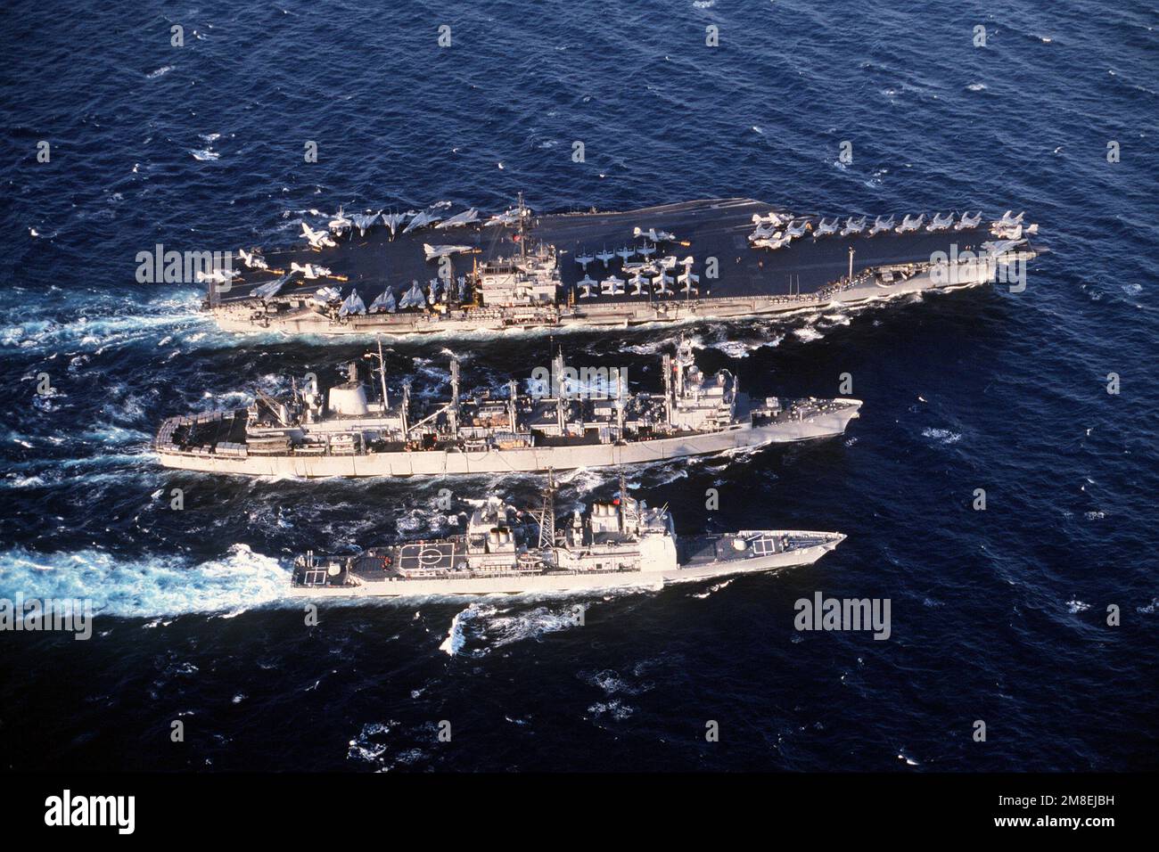 The fast combat support ship USS DETROIT (AOE-4), is flanked by the ...