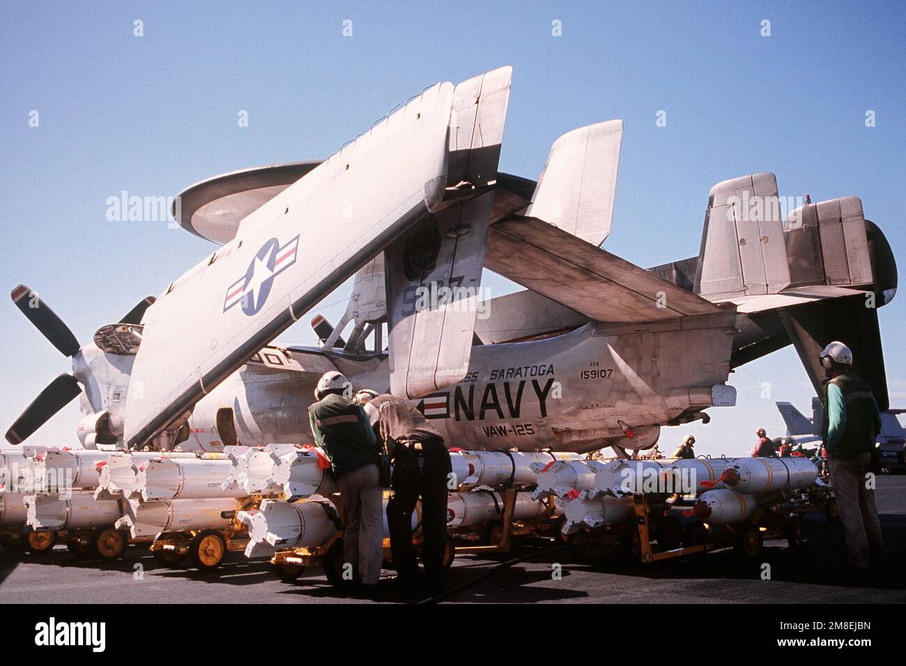 Ordnancemen examine one of several bomb carts loaded with Mark 20 ...