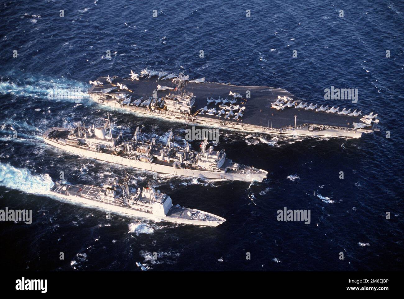 The fast combat support ship USS DETROIT (AOE-4), is flanked by the ...