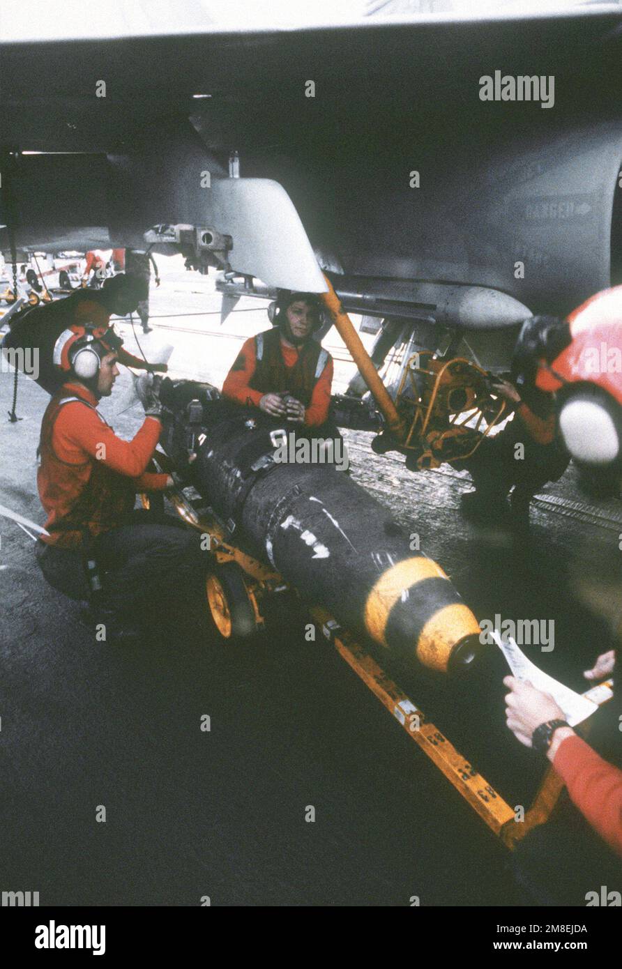 Aviation odnancemen use an HLU-196 bomb hoist to lift a Mark 84 2,000 ...