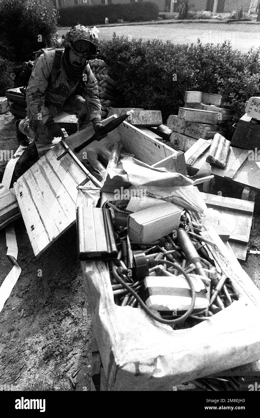 A Marine displays a rocket-propelled grenade taken from a crate at the ...