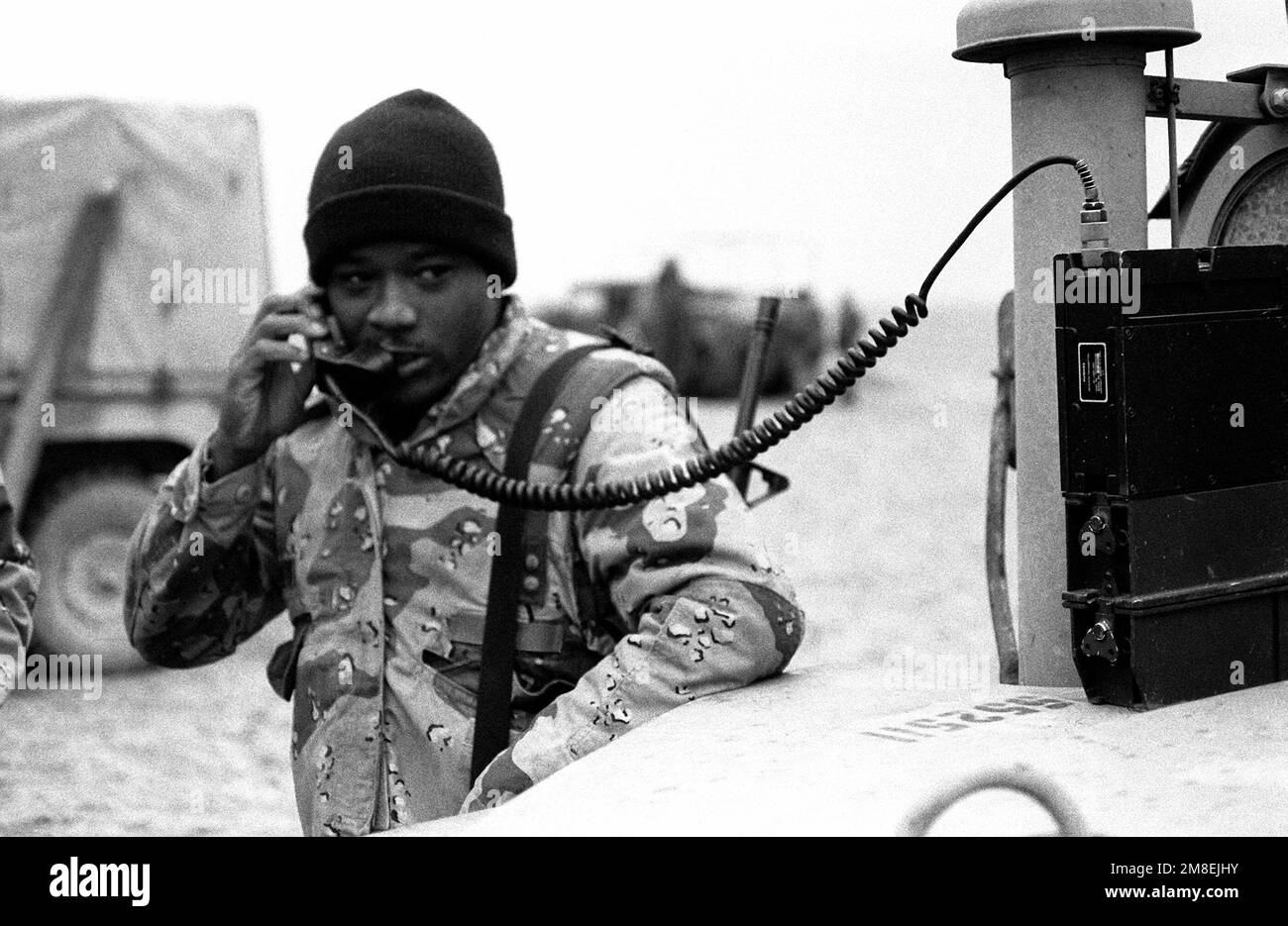 A Marine uses a field radio to communicate with another unit after ...
