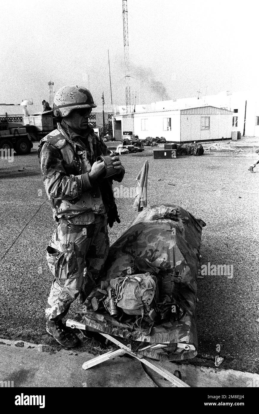 A Marine from the 1ST Marine Division stands beside his cot as he ...