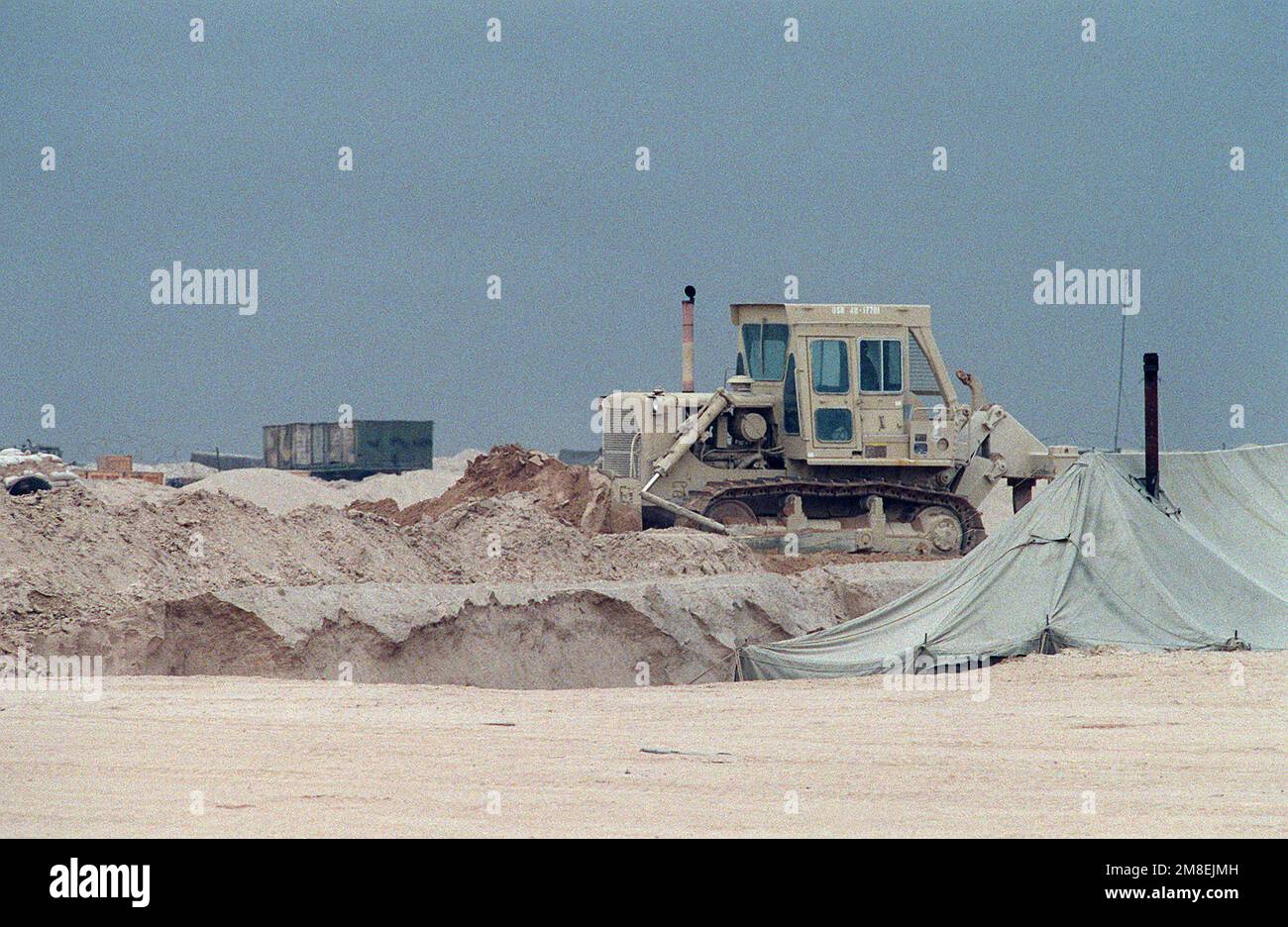 A Naval Mobile Construction Battalion 5 (NMCB-5) bulldozer moves sand ...