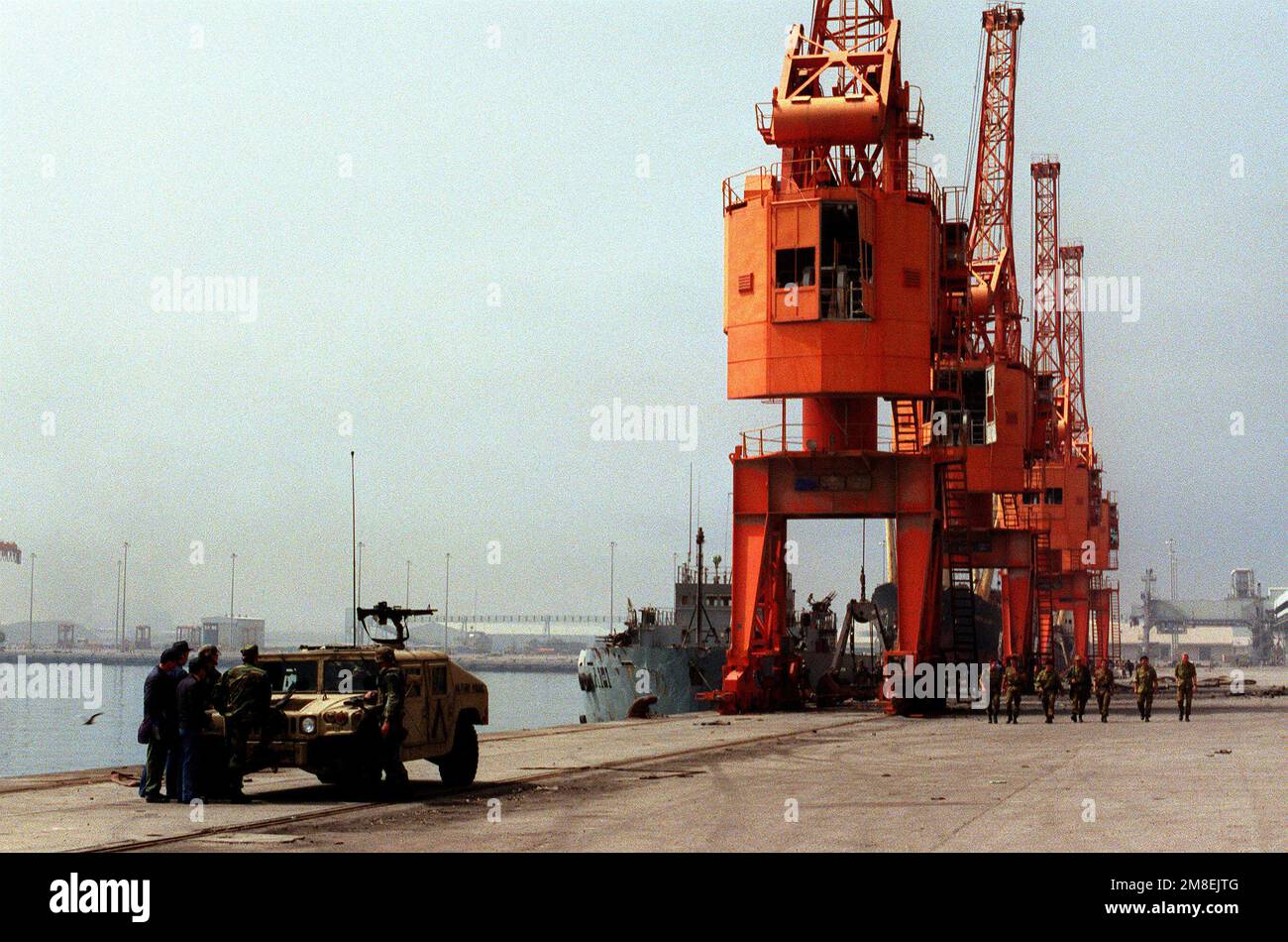 Several sailors and military policemen gather beside an M1038 High ...
