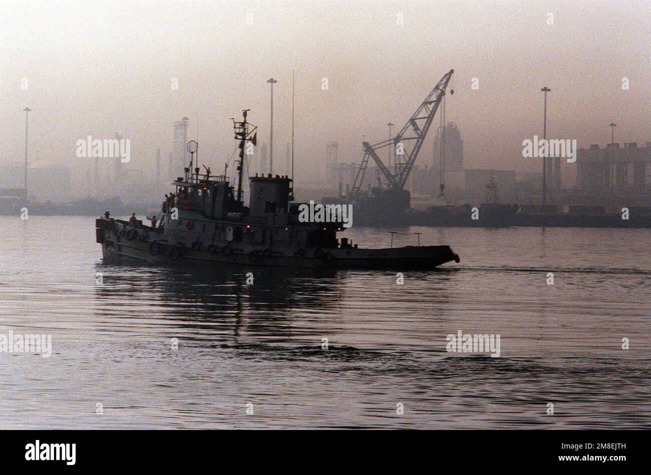 A U.S. Army tug boat crosses the harbor after the re-opening of the ...