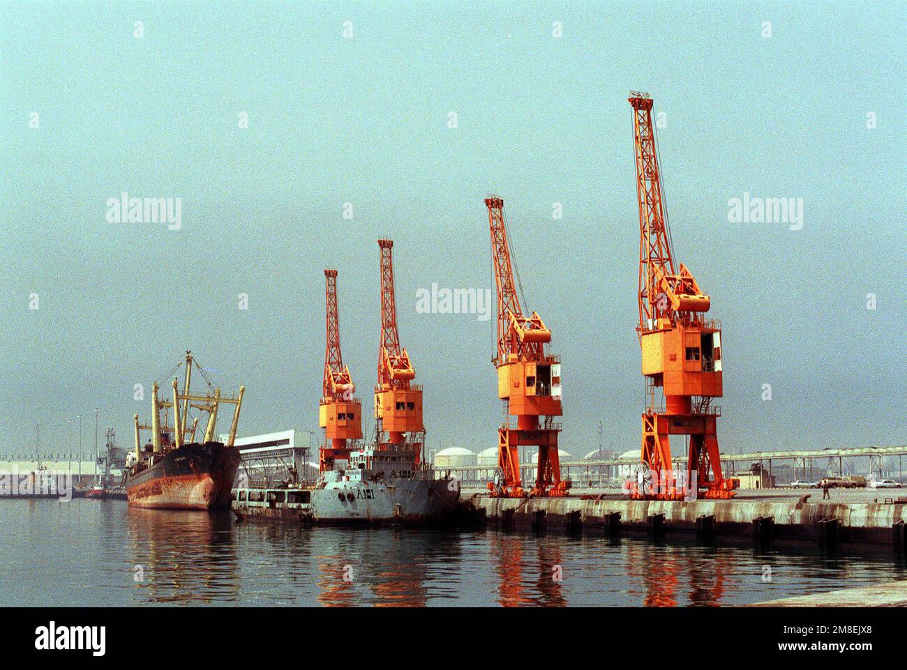 A merchant ship, left, and a captured Iraqi vessel lie tied up to the ...