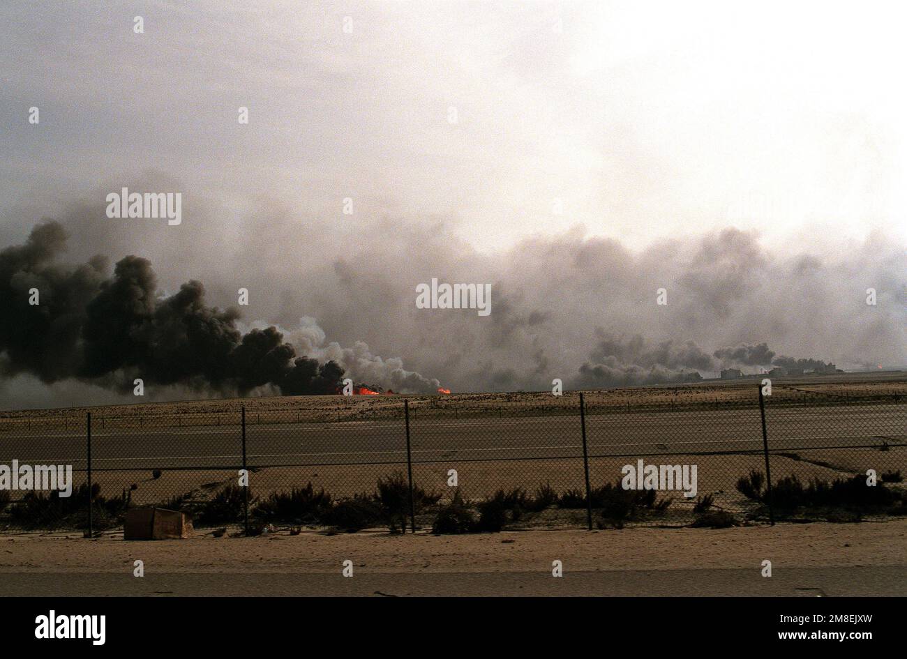 An oil field burns outside of Kuwait City after being set ablaze by ...