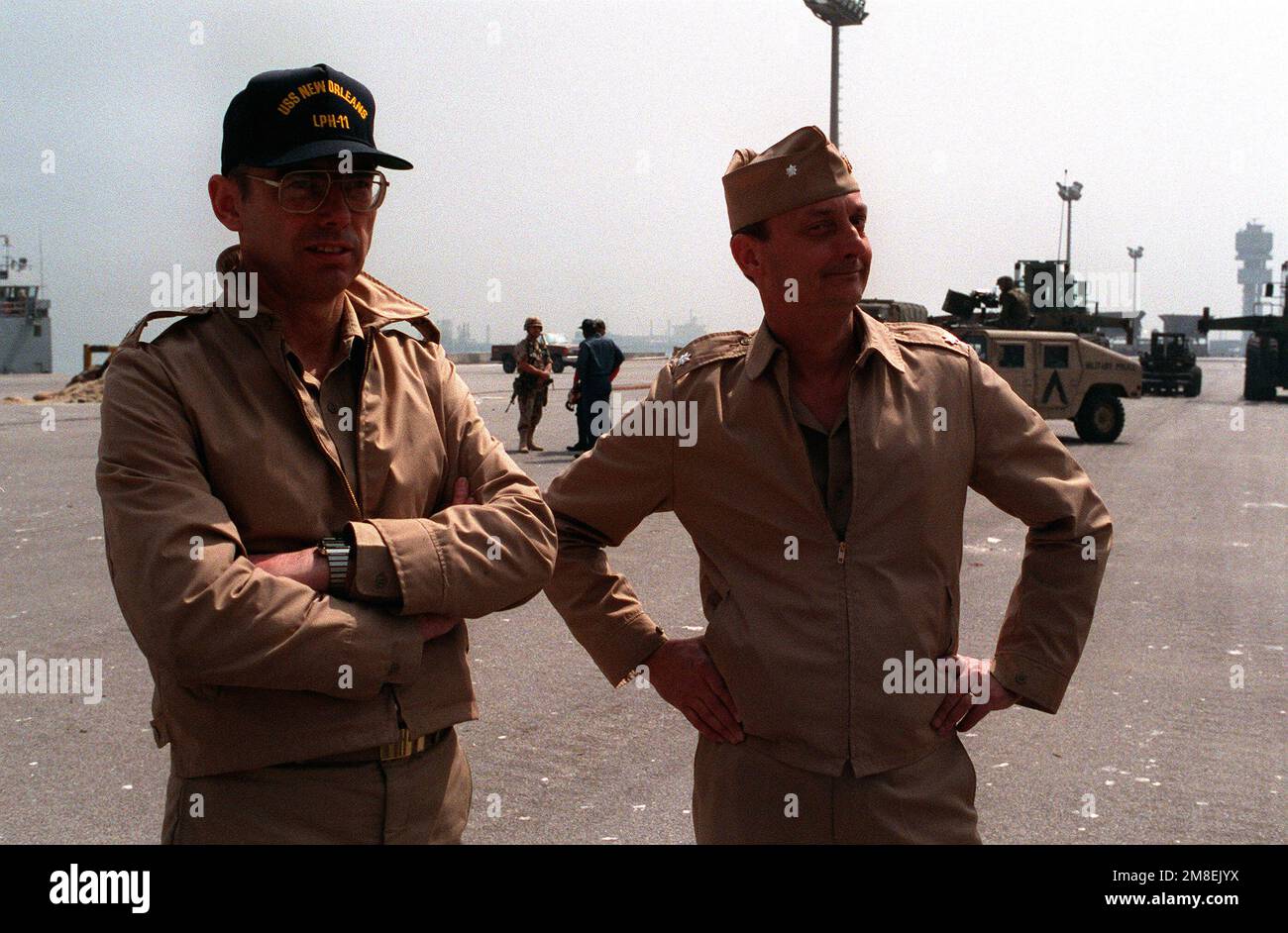 Two U.S. Navy officers stand on the dock following the re-opening of ...