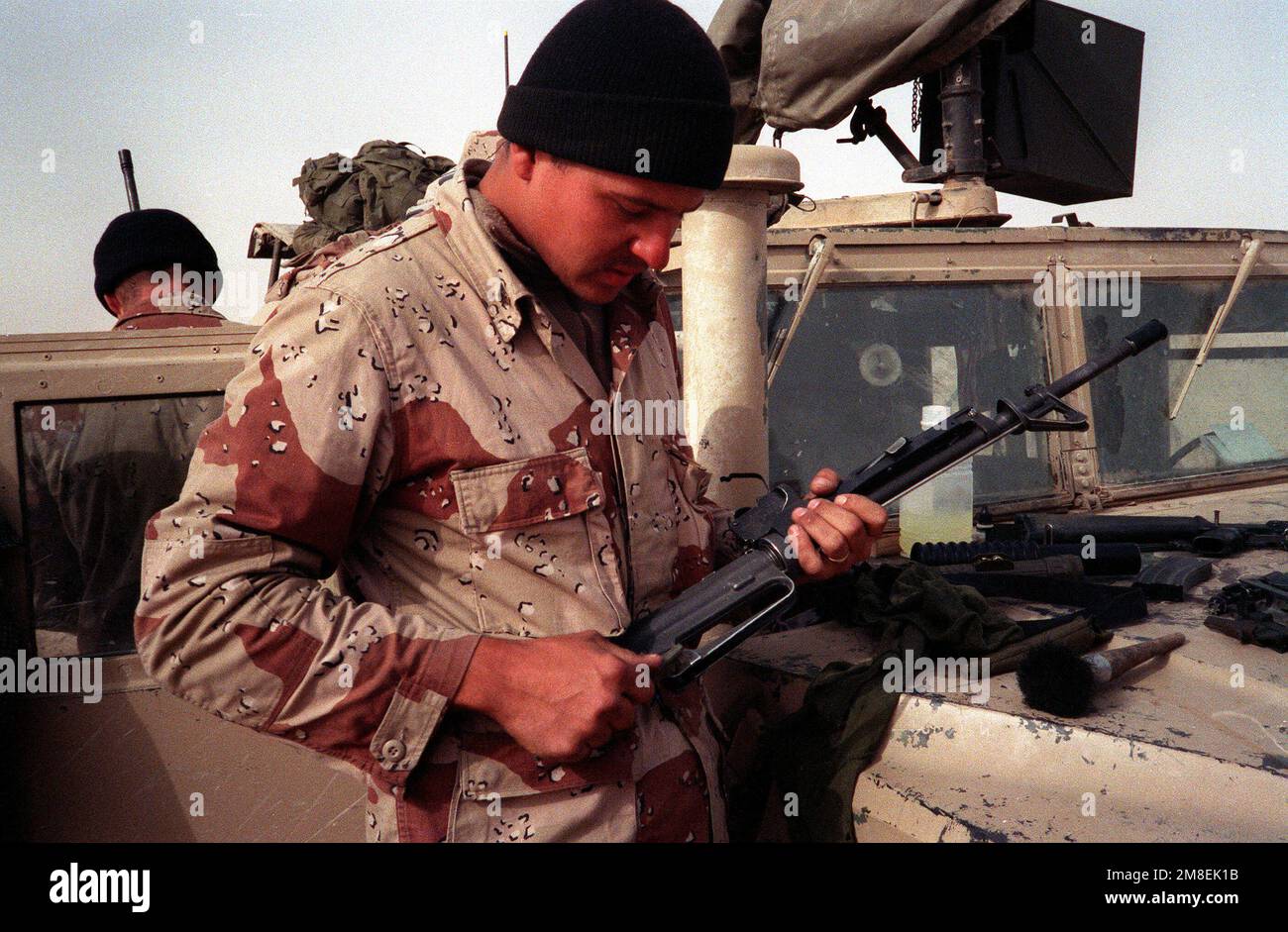 A Marine uses the hood of an M998 High-Mobility Multipurpose Wheeled ...
