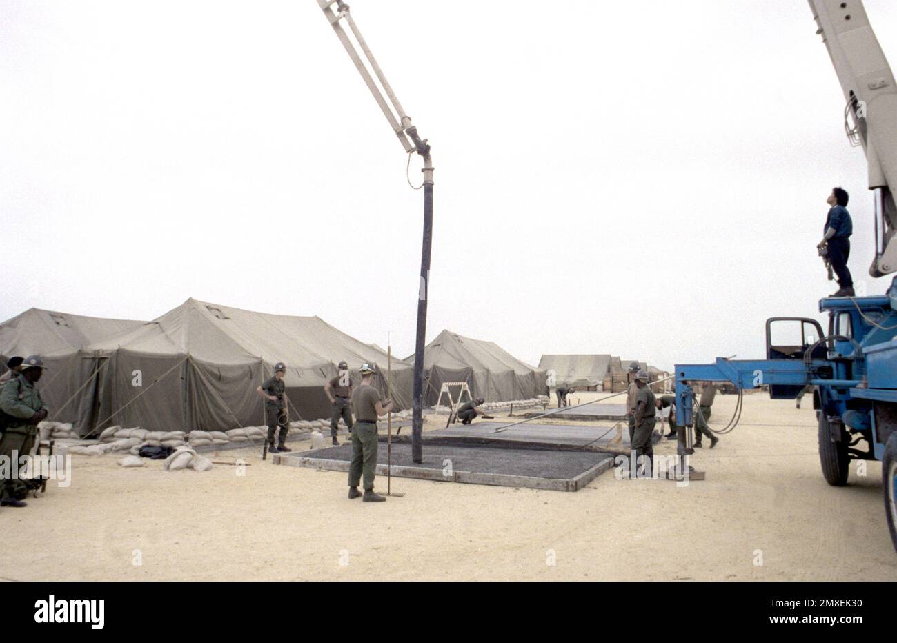 Members of Naval Mobile Construction Battalion 5 pour concrete for a ...
