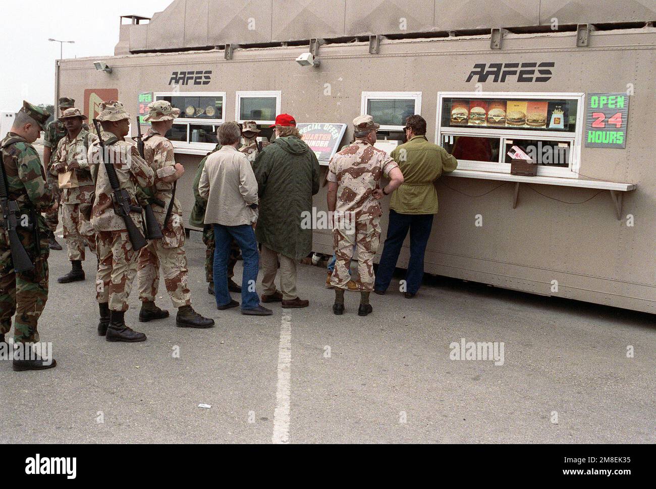 Off-duty Marines and sailors wait in line at an Army and Air Force ...