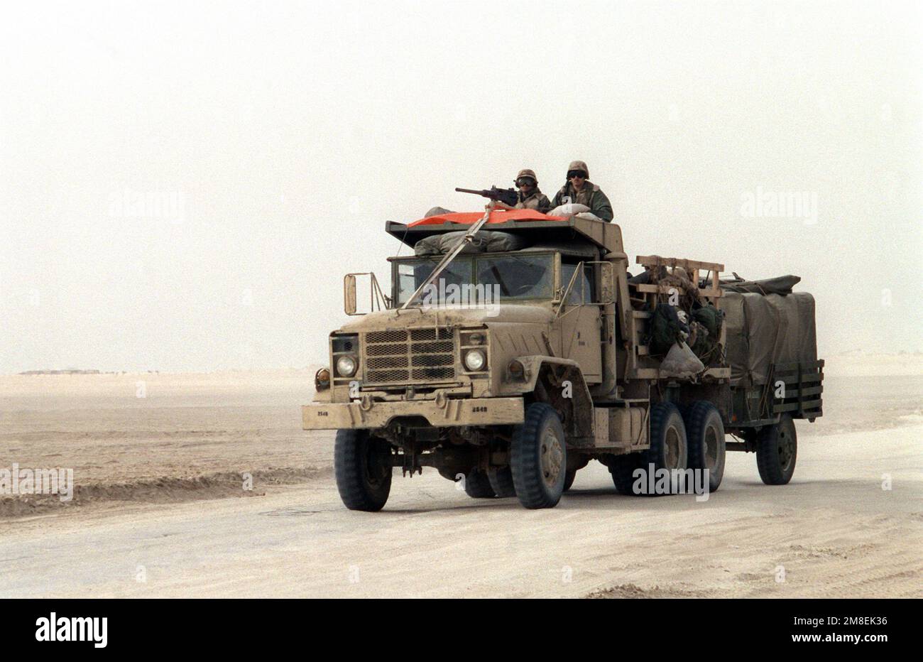 Members of Naval Mobile Construction Battalion 5 travel along a main ...