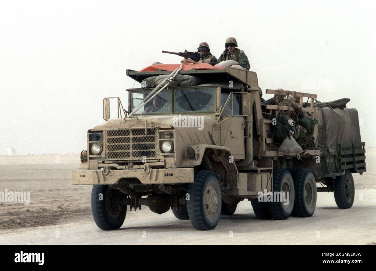 Members of Naval Mobile Construction Battalion 5 travel along a main ...