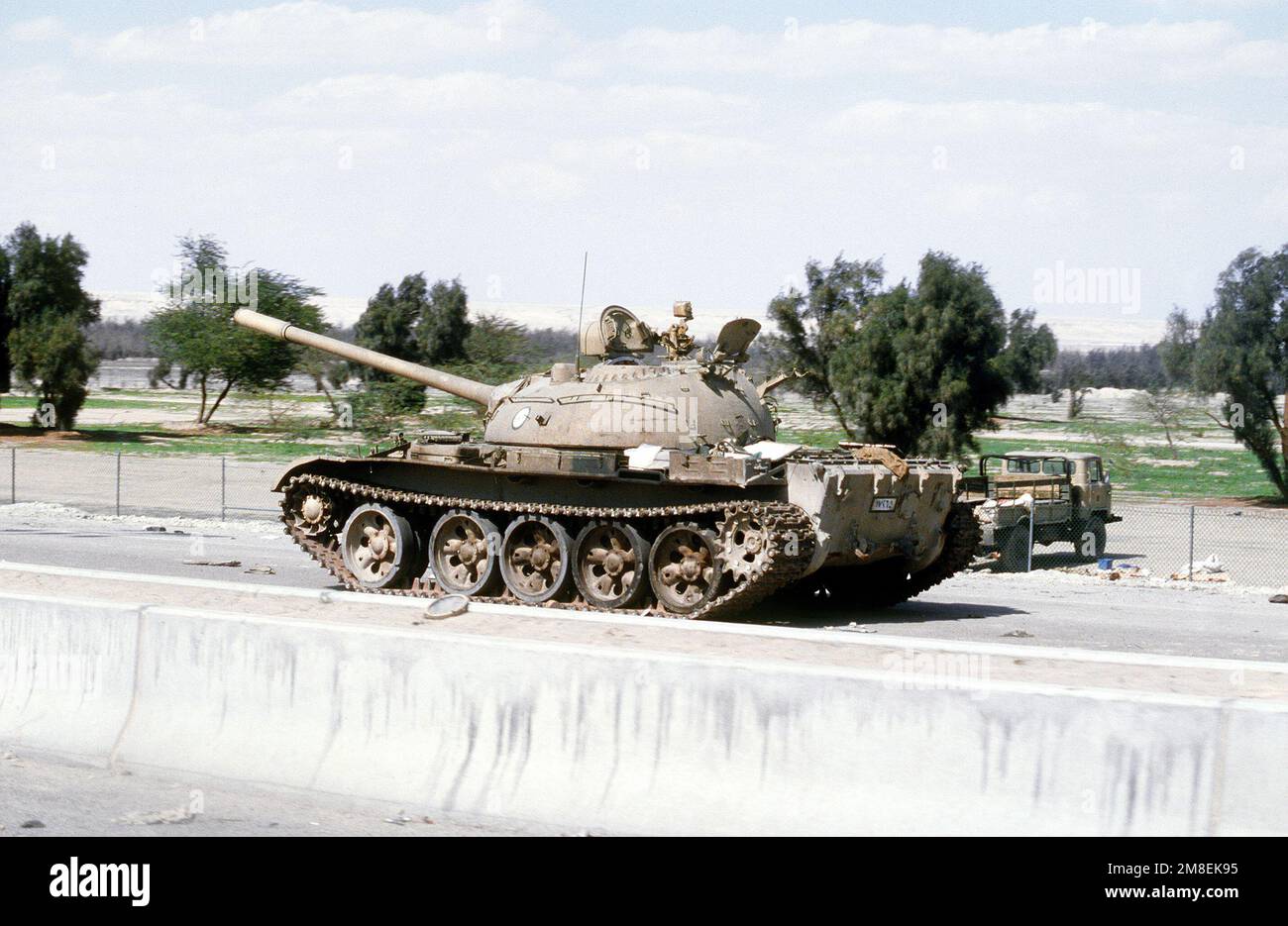 An Iraqi T-55 main battle tank sits on a road after being abandoned ...