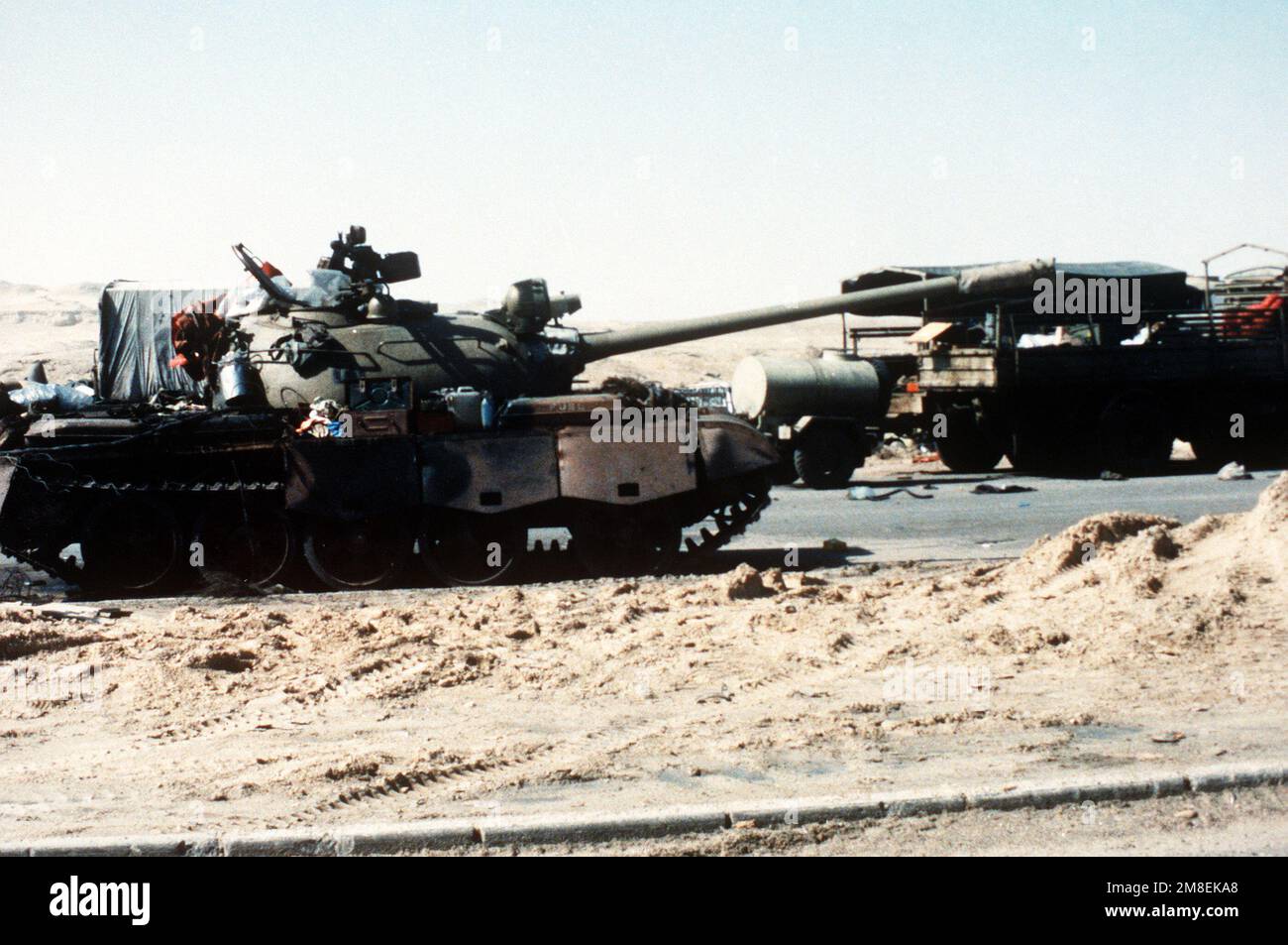 A damaged Iraqi Type 69-II tank sits beside a road after being ...