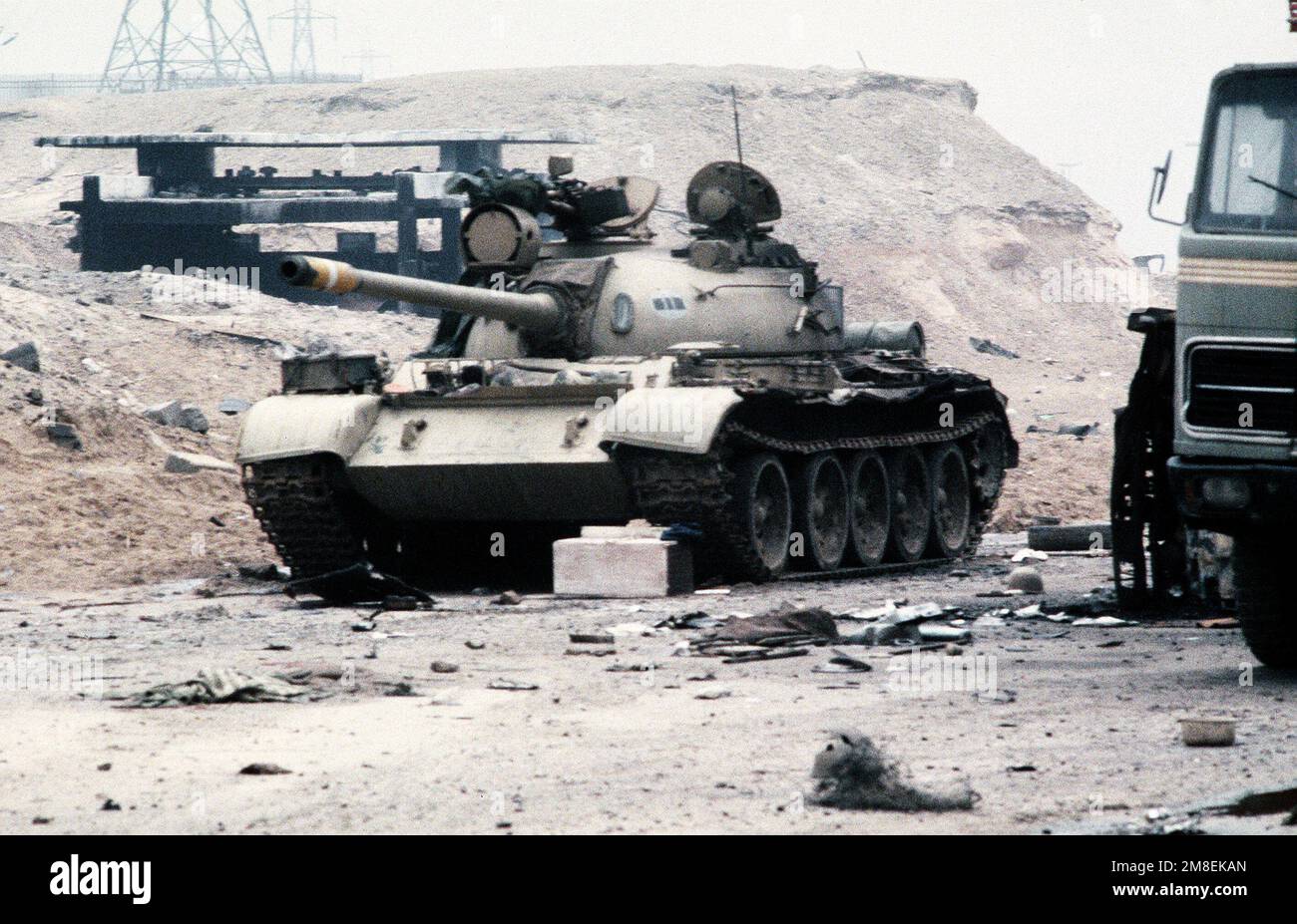 A damaged Iraqi T-55 main battle tank sits at the foot of a hill after ...