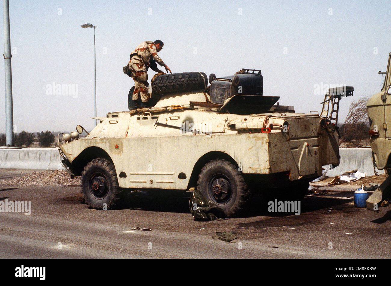 An American serviceman examines an Iraqi BRDM-2 amphibious scout car ...