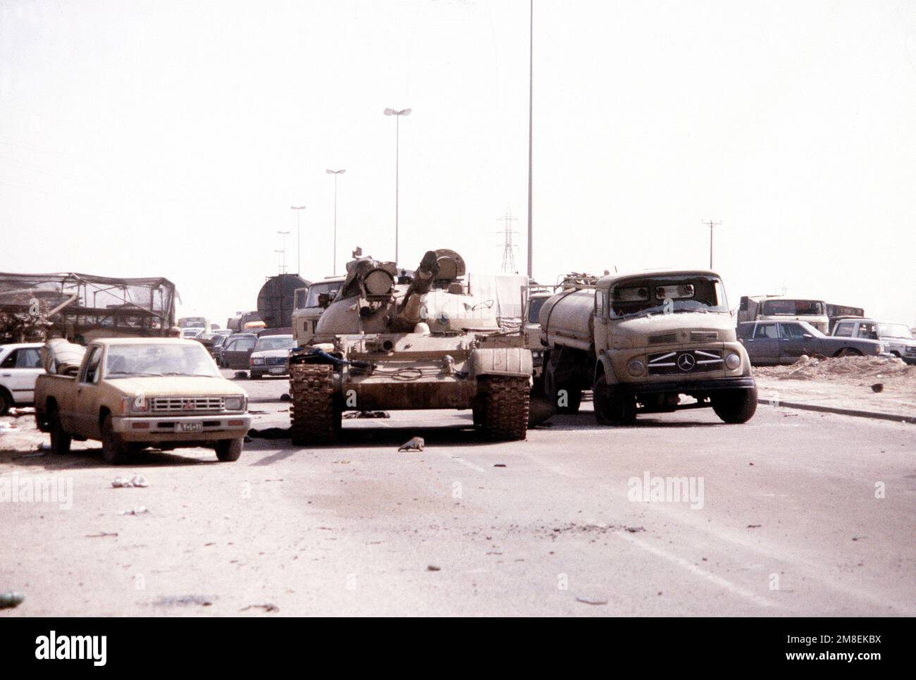 An Iraqi T-62M main battle tank sits between a pair of trucks after ...