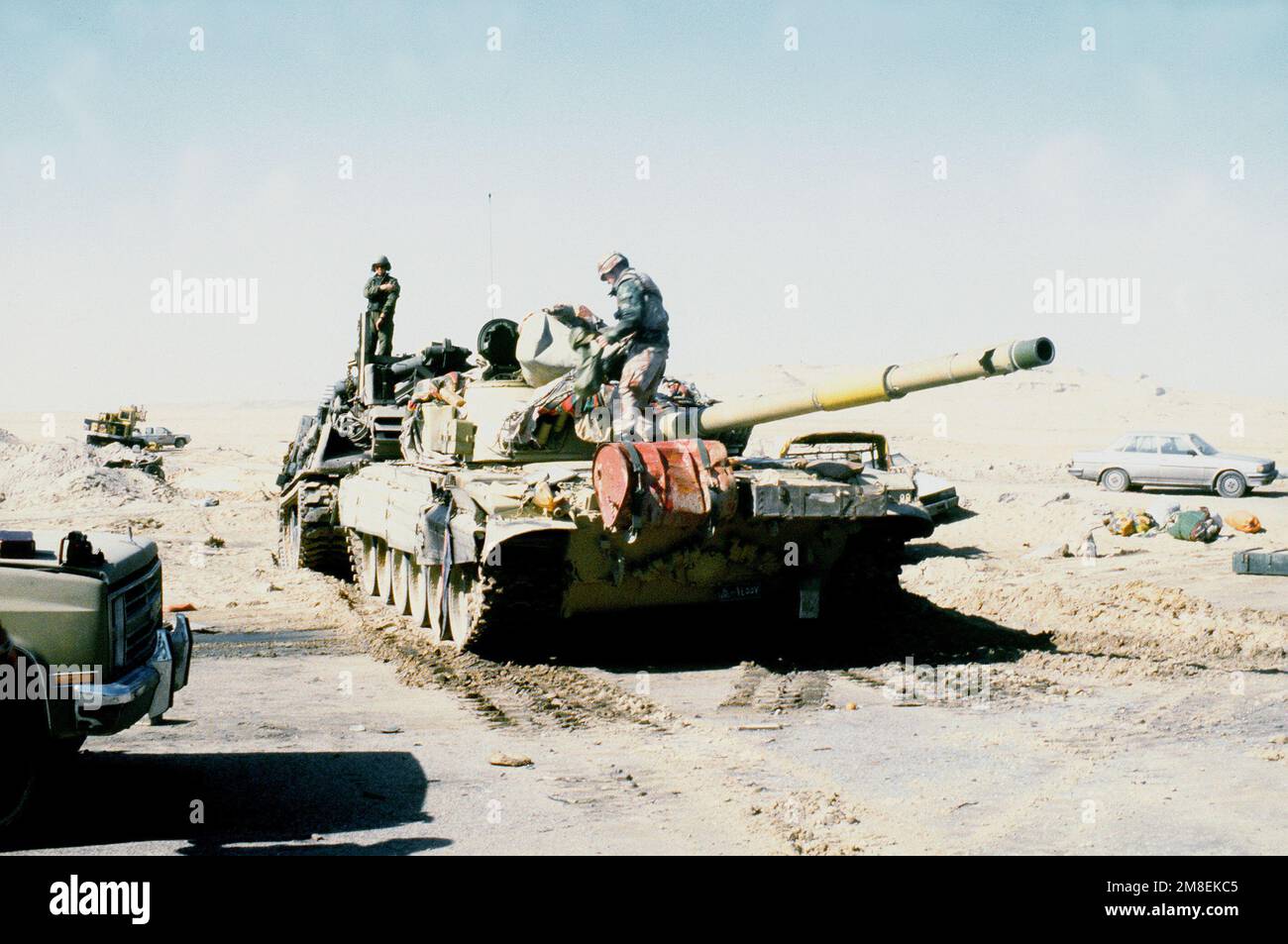 American servicemen check over an Iraqi T-72 main battle tank that was ...