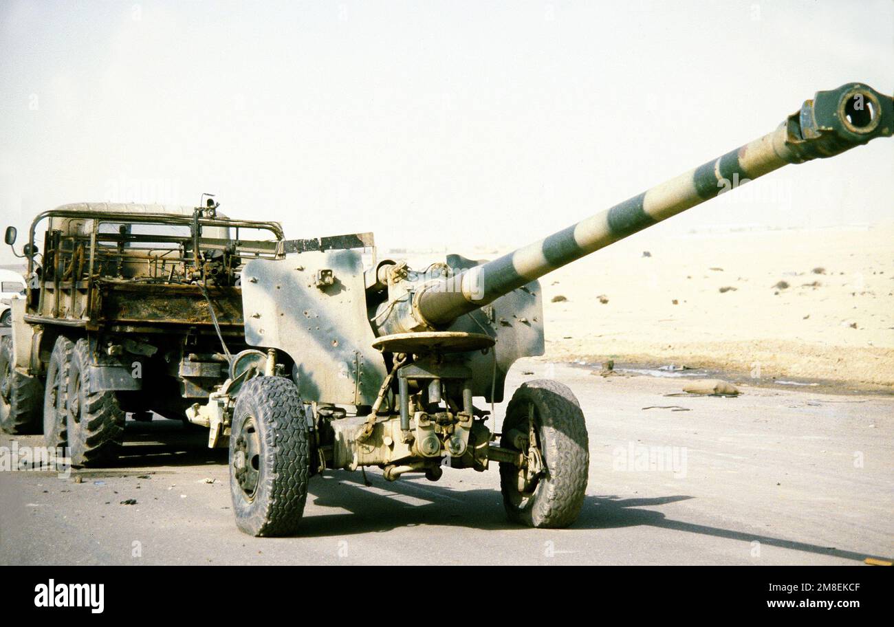 An Iraqi Type 59 130mm field gun sits behind a burned-out truck on the ...