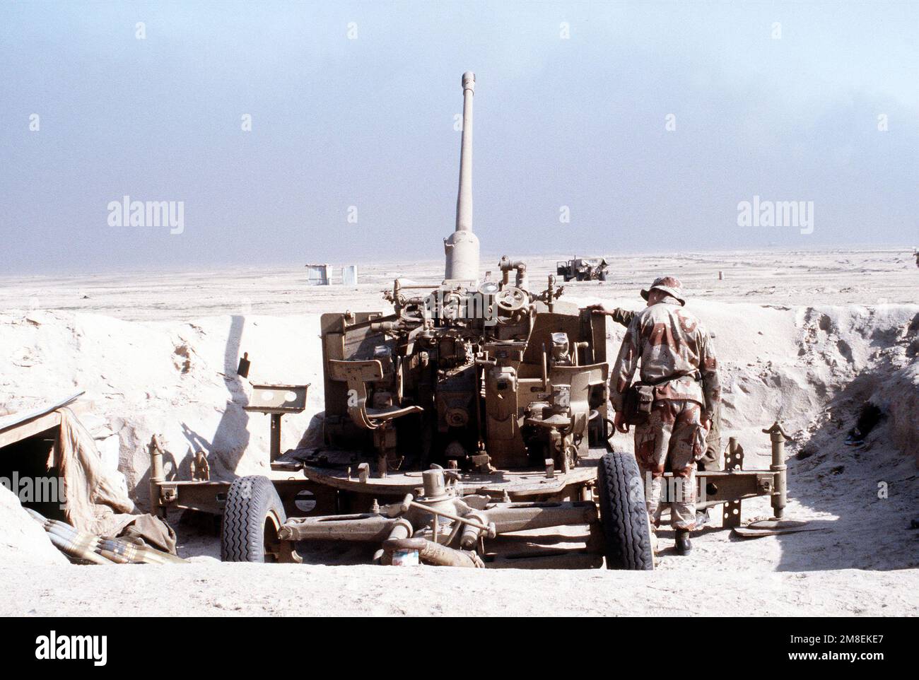 Two servicemen examine an Iraqi S-60 57mm automatic anti-aircraft gun ...