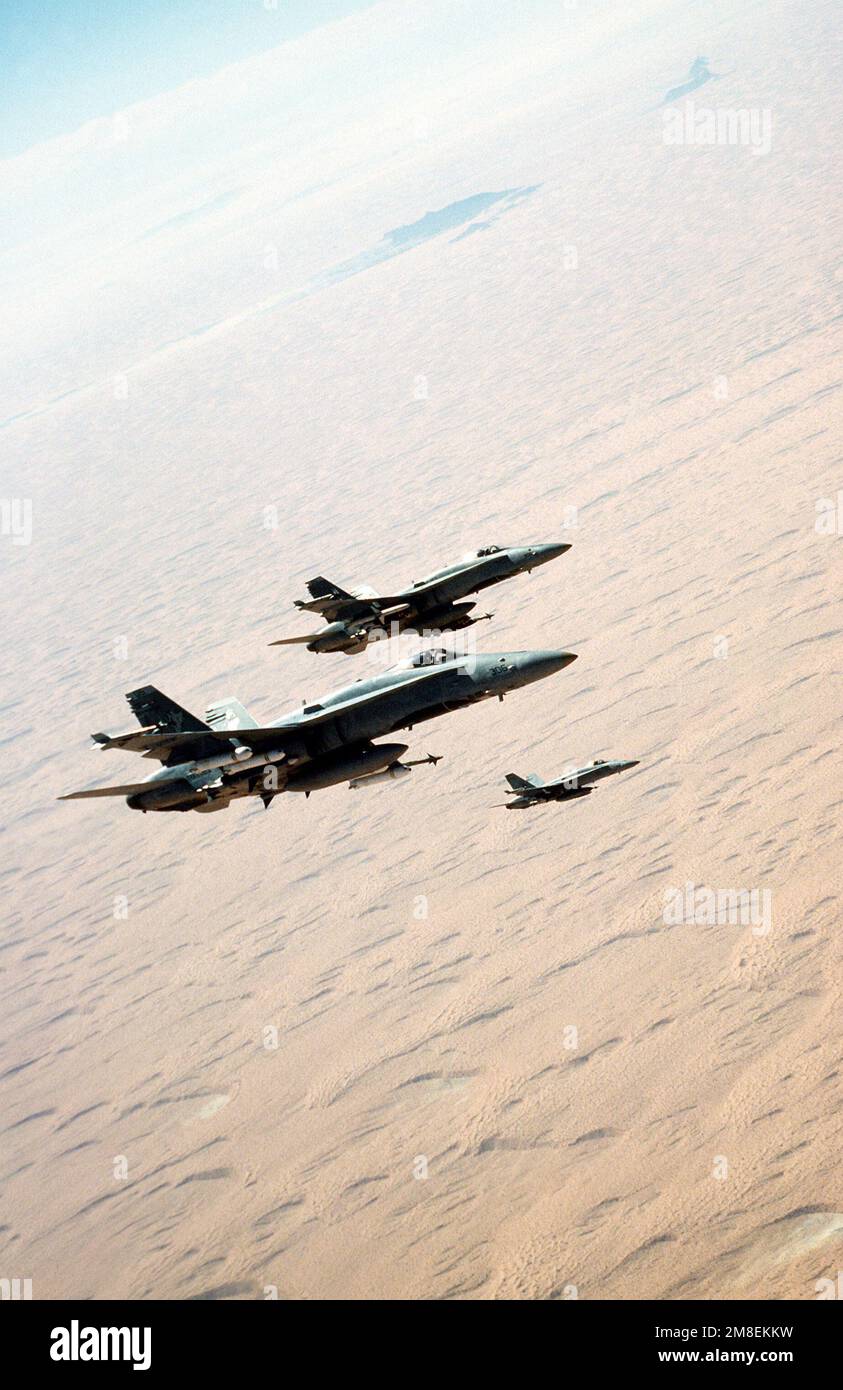 F/A-18C Hornet aircraft fly in formation over the desert during ...