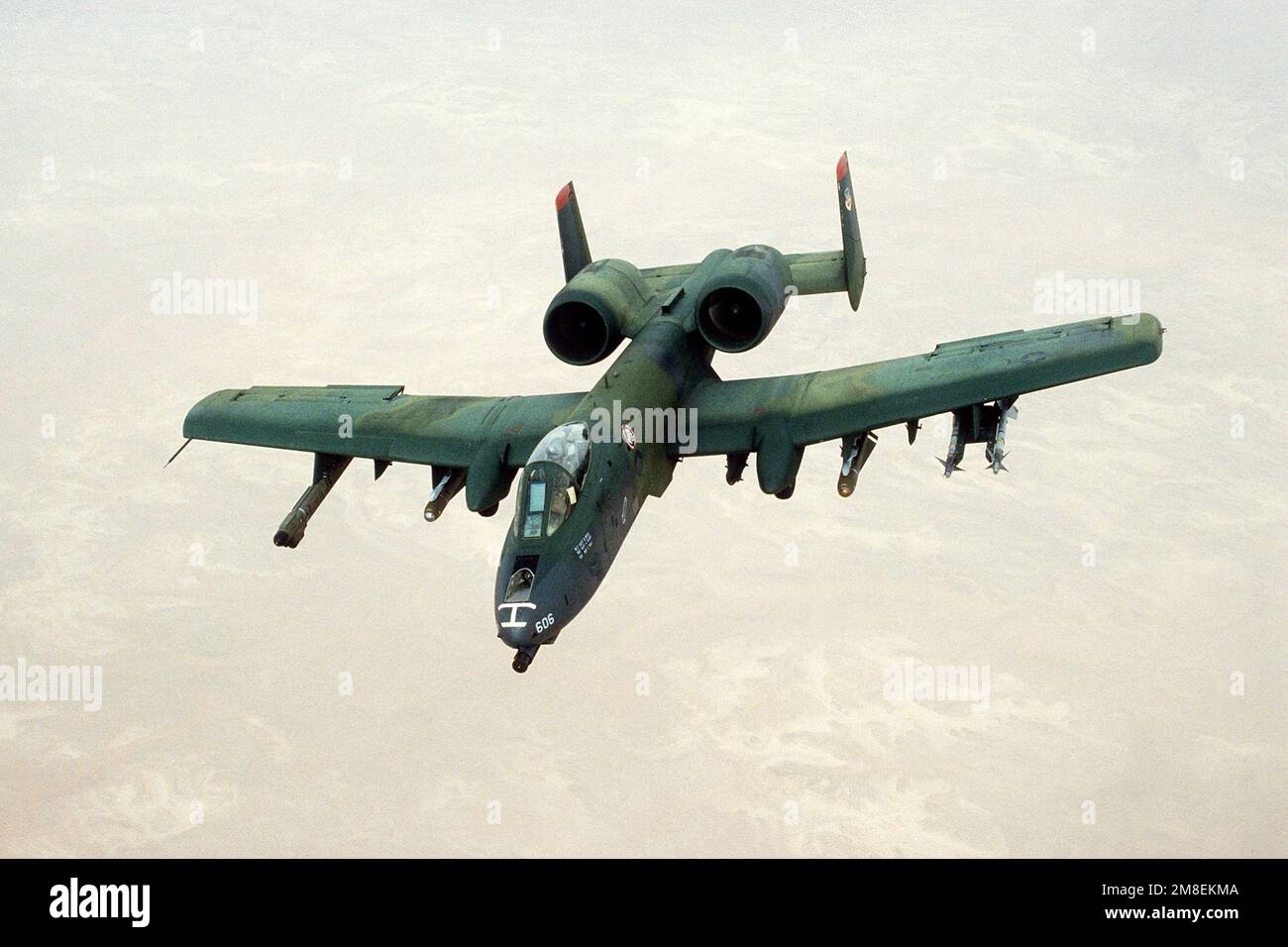 An A-10A Thunderbolt II aircraft flies over the desert during Operation ...