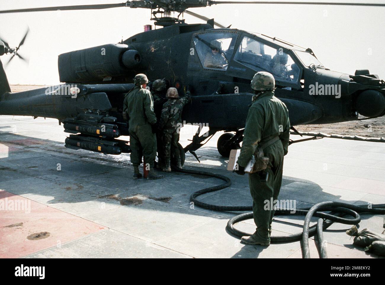 Members of the 102nd Quartermasters Company refuel an AH-64 Apache ...