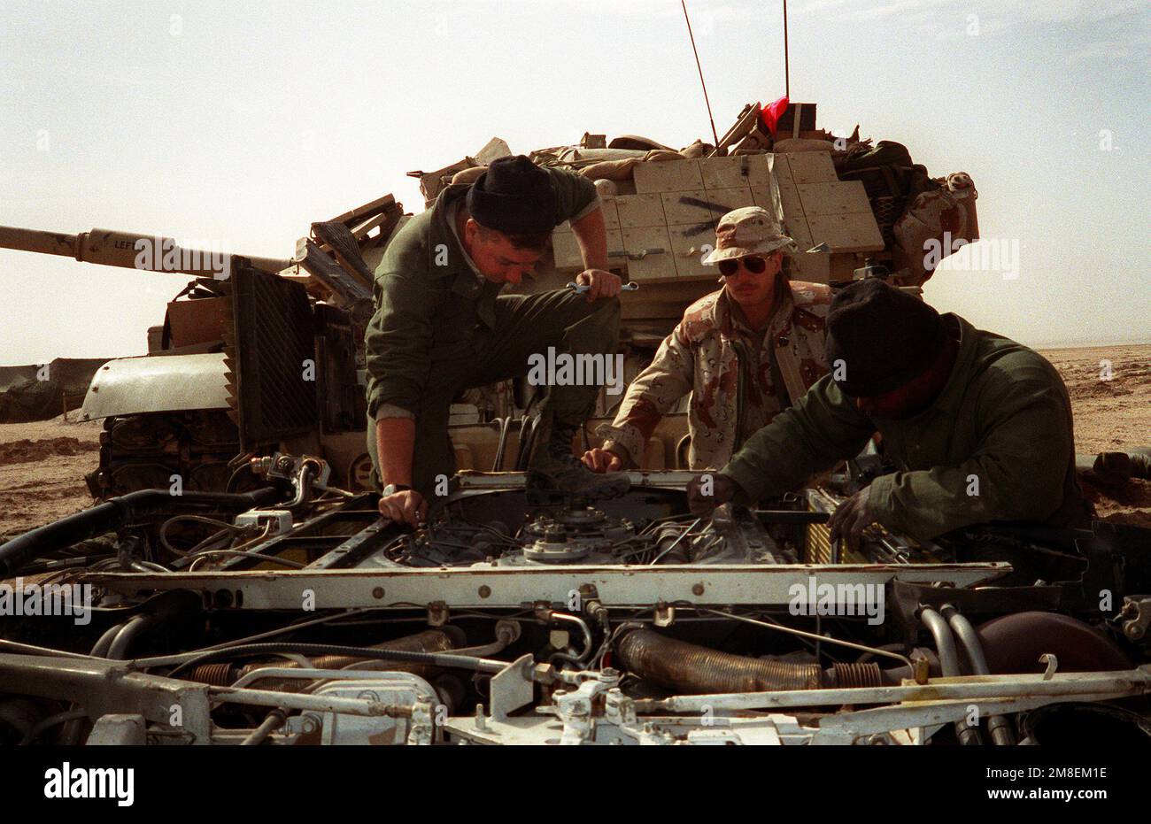 Marines work on the power pack from an M-60A1 tank at a camp in ...