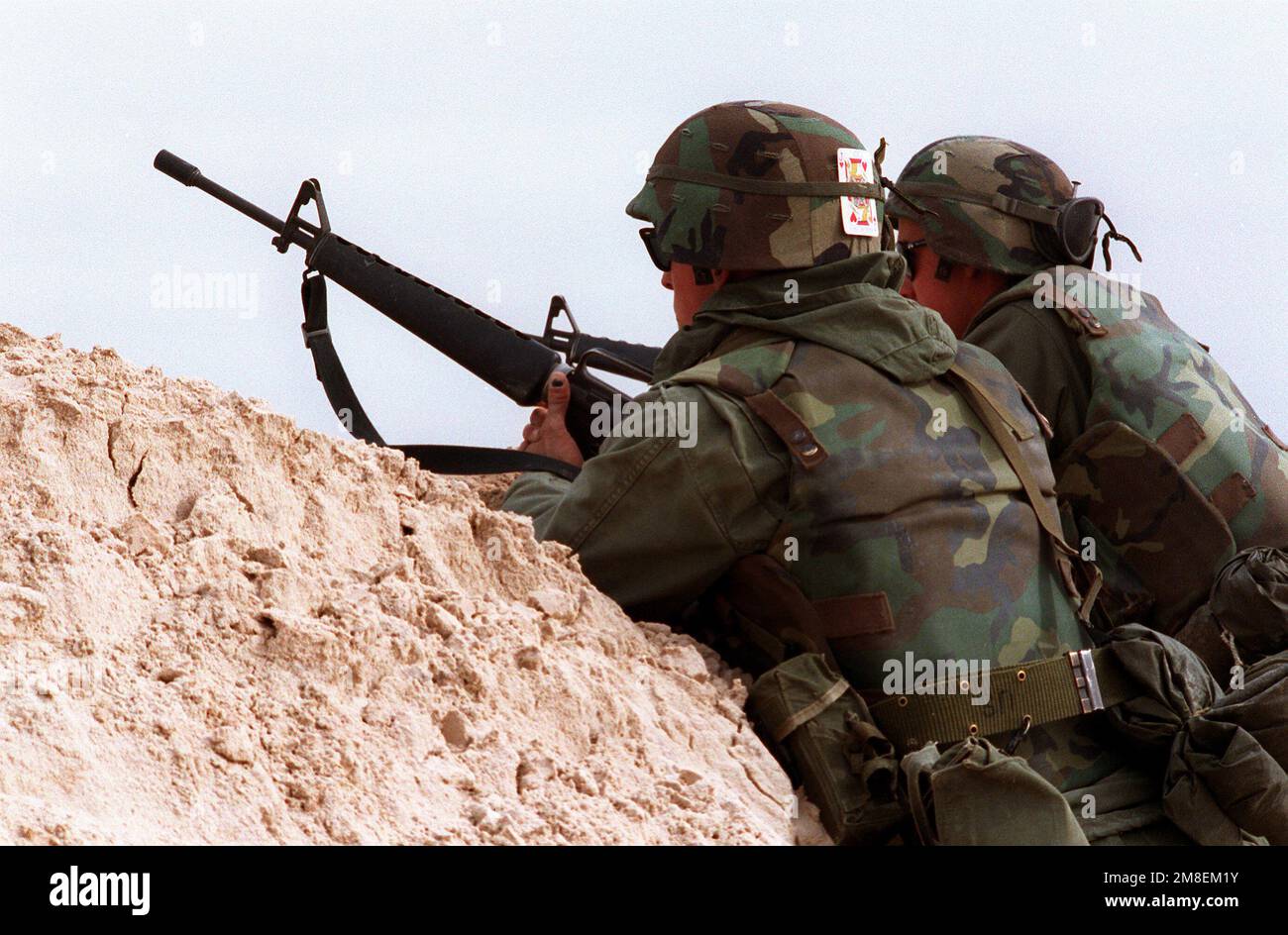 Two Seabees from Naval Mobile Construction Battalion 5 (NMCB-5) take up ...