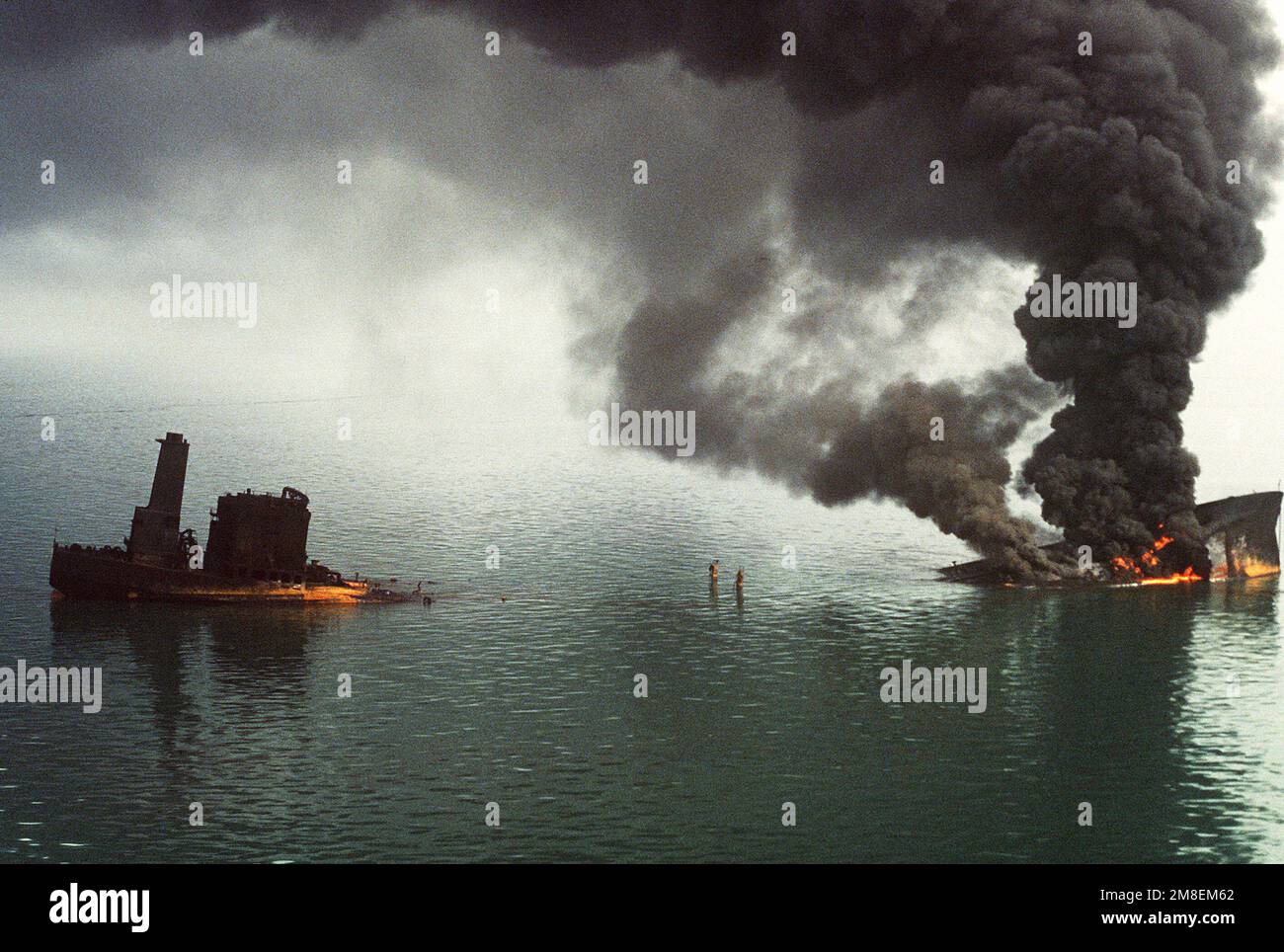Black smoke pours from the sinking remains of an Iraqi oil tanker that ...