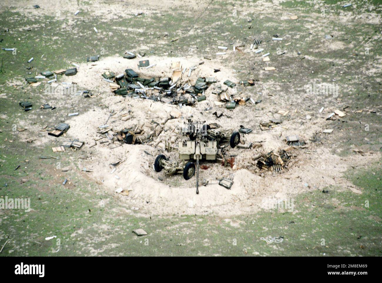 A view of an Iraqi anti-aircraft gun, ordnance, and bunker on Umm A1 ...