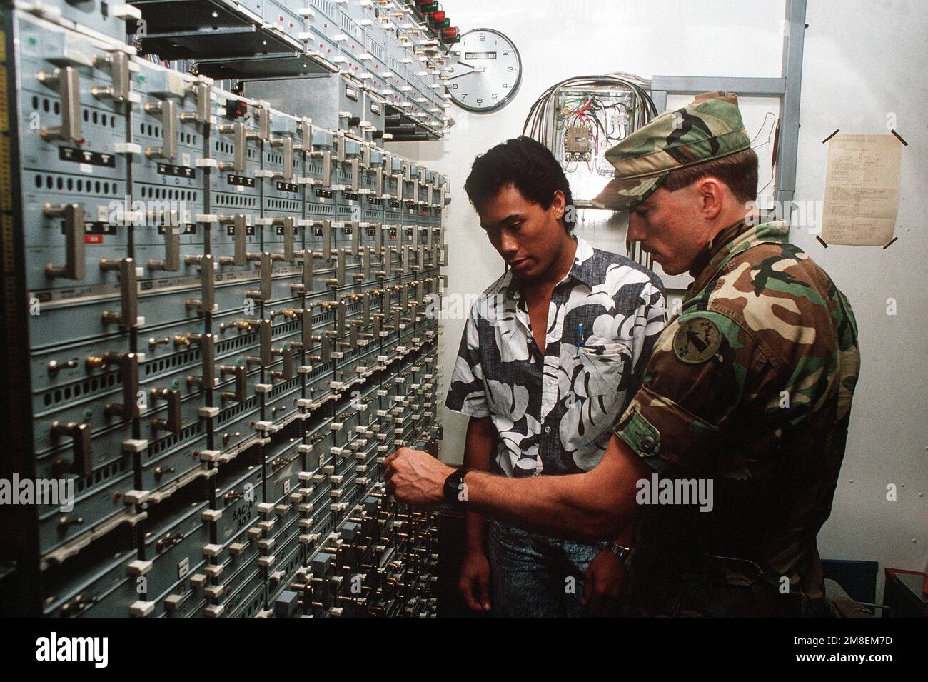 SSGT Kevin Sergeant, 7th Maintenance Battalion, explains telephone line patching to Dennis ...