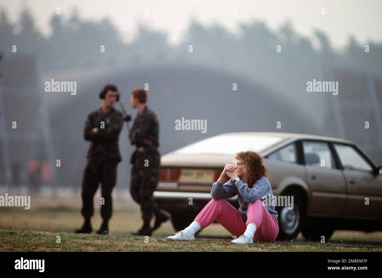 A woman watches as F-111F aircraft depart for Saudi Arabia in support ...