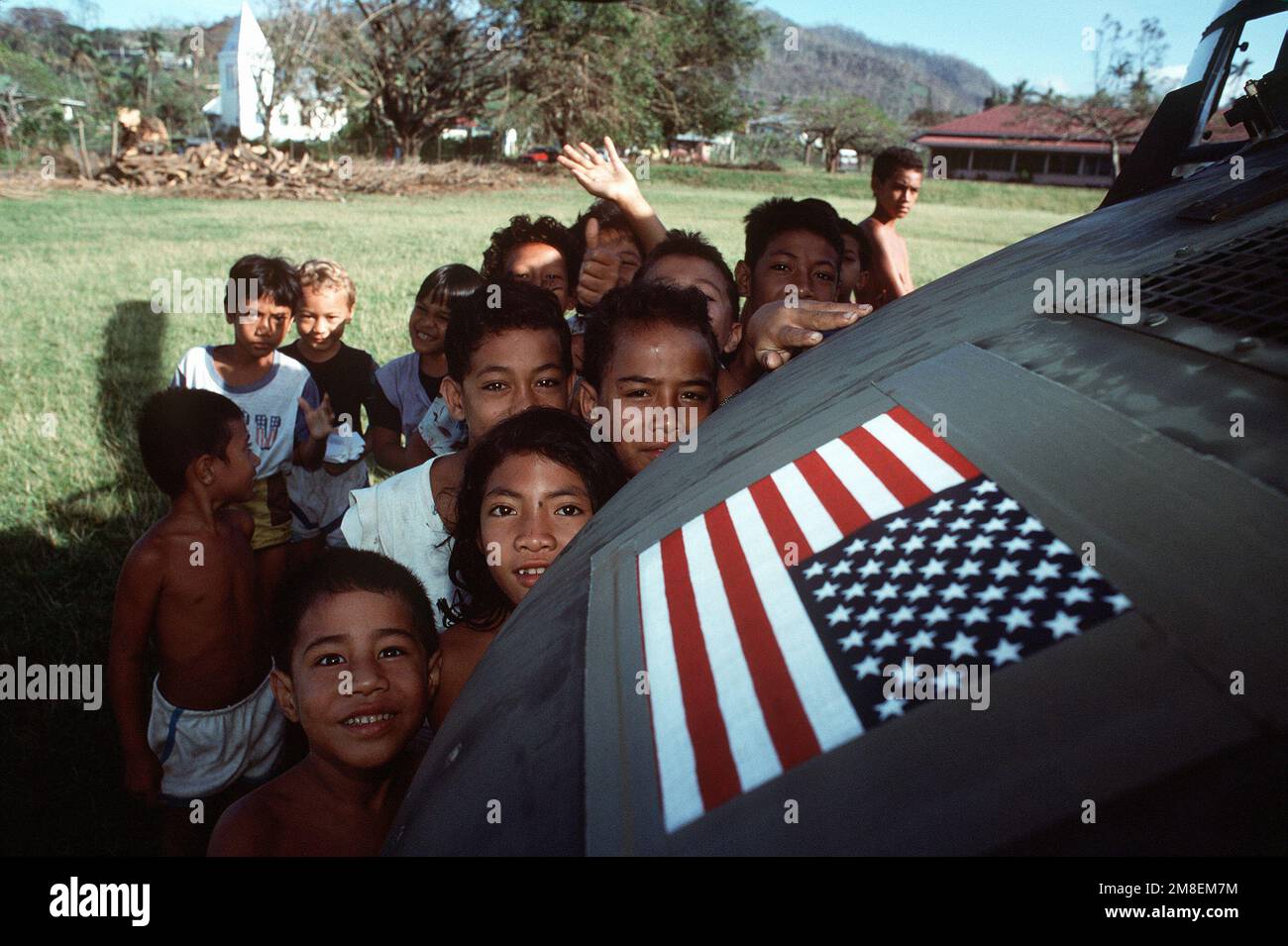 Samoan children gather near a 53rd Aviation Battalion UH-60 Black Hawk ...