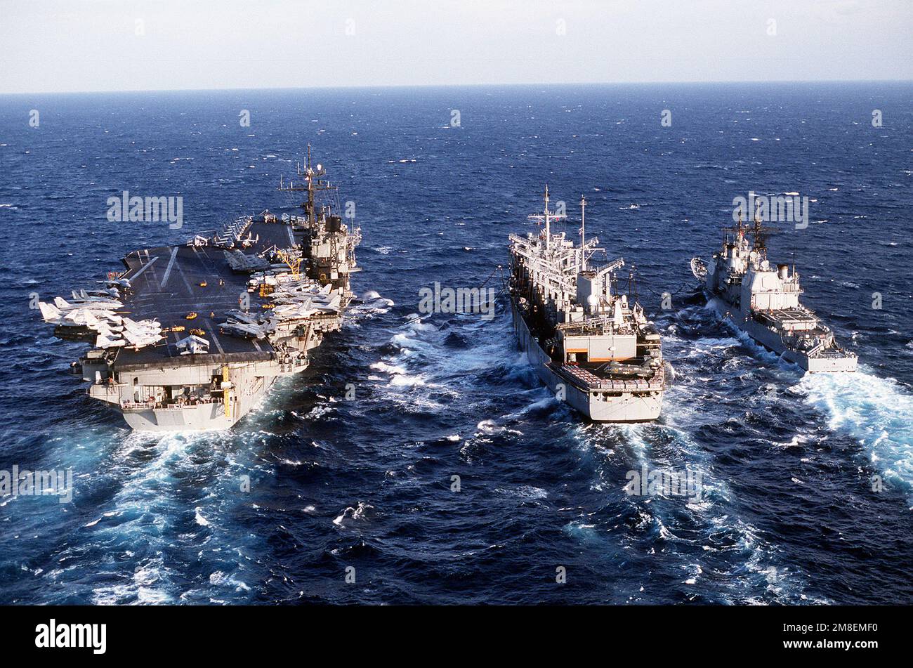 The fast combat support ship USS DETROIT (AOE-4) is flanked by the ...