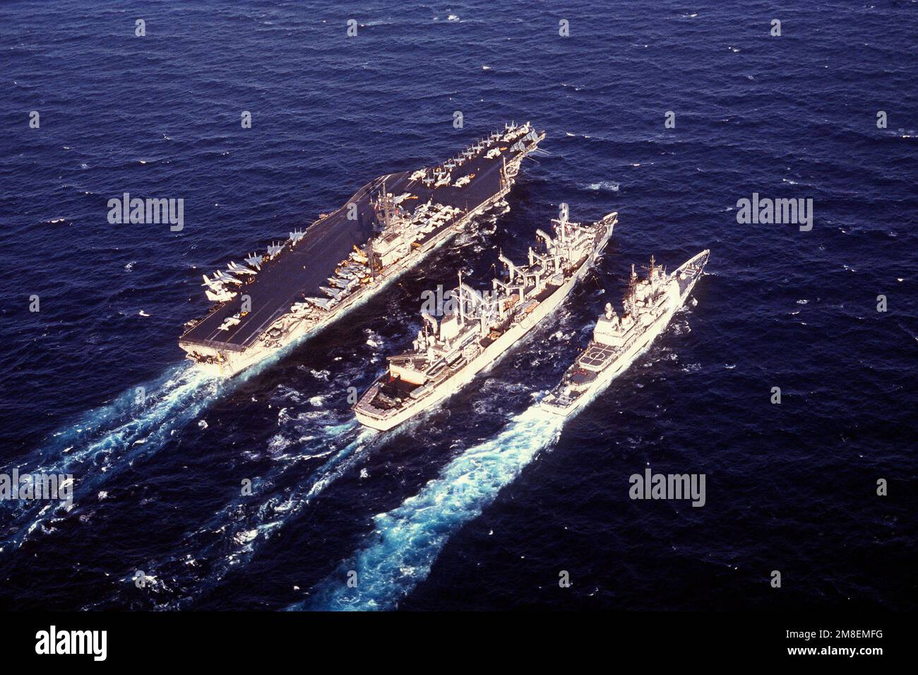 The fast combat support ship USS DETROIT (AOE-4) is flanked by the ...