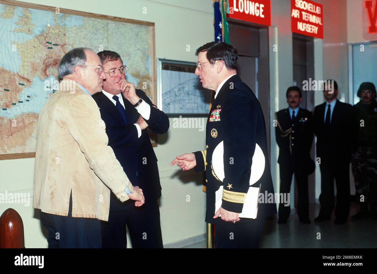 An officer speaks with Secretary of Defense Richard Cheney and a ...