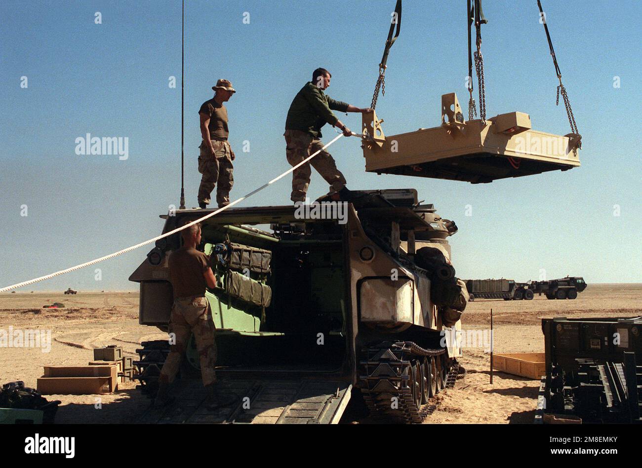 A Marine assigned to Task Force Breach Alpha stands atop an AAVP-7A1 ...