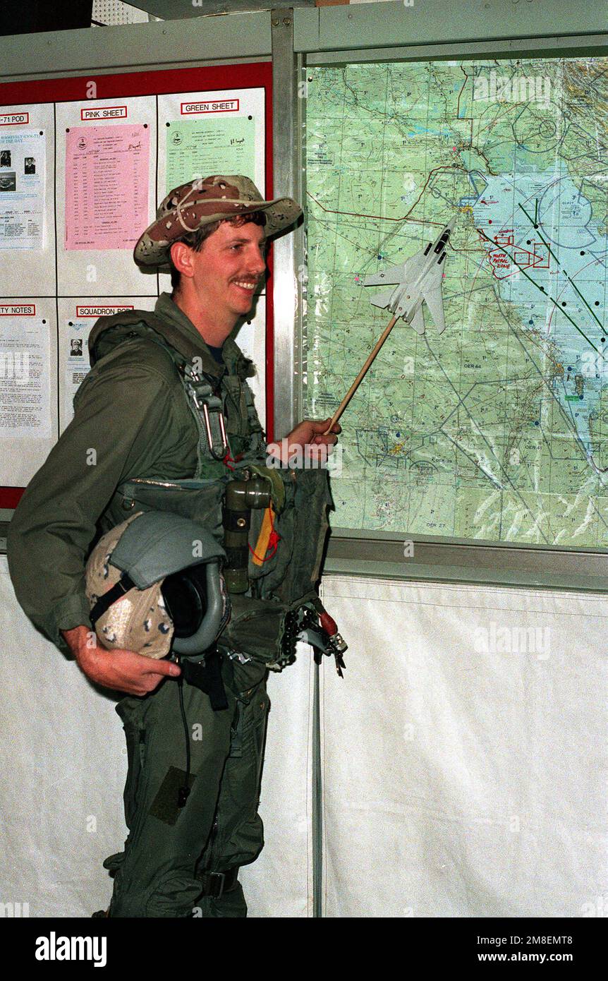 LT. Steve White of Fighter Squadron 41 (VF-41) points to Kuwait City on ...