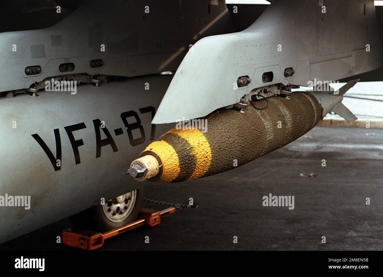 A Mark 82 500-pound general-purpose bomb hangs from a pylon beneath the ...