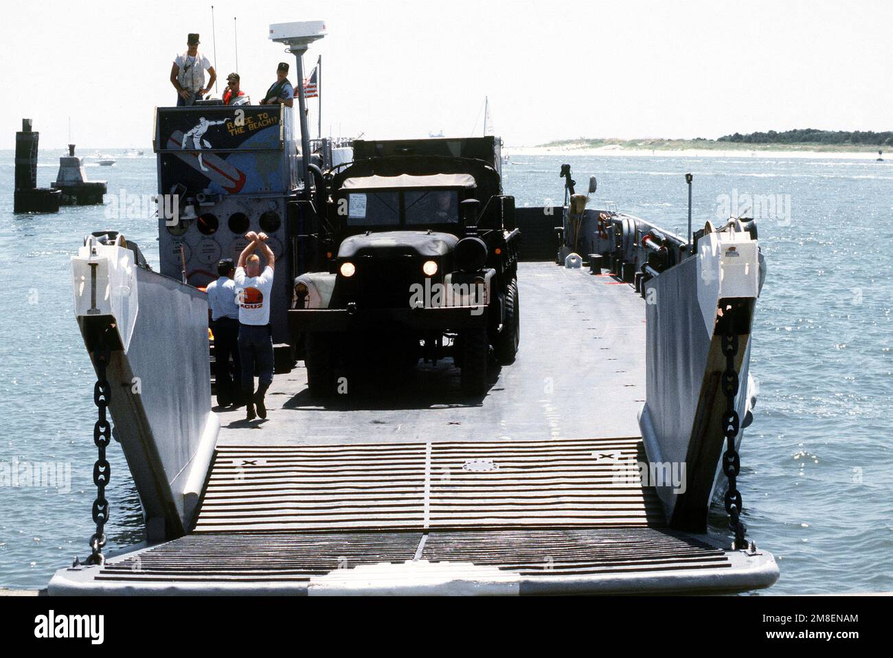 An M-41 5-ton truck is loaded onto a utility landing craft for ...