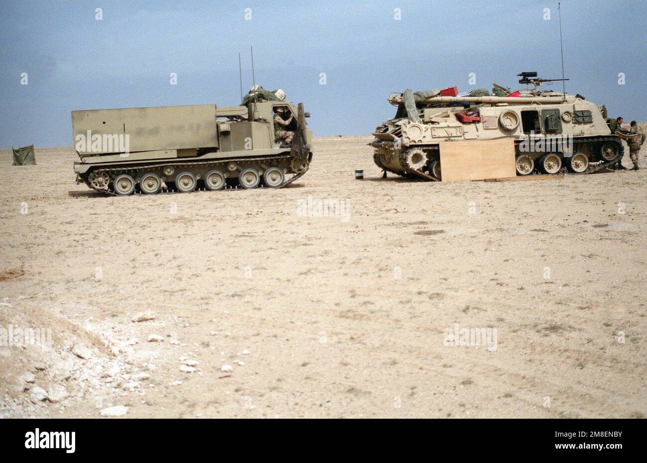 An M-270 armored vehicle-mounted rocket launcher (AVMRL), left, and an ...