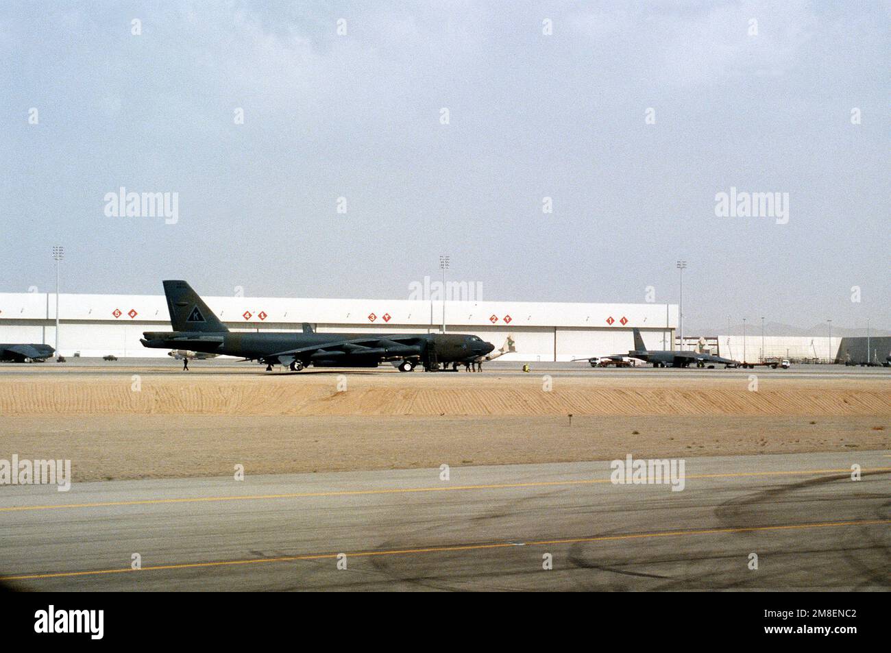 B-52G Stratofortress aircraft are serviced on the flight line prior to ...