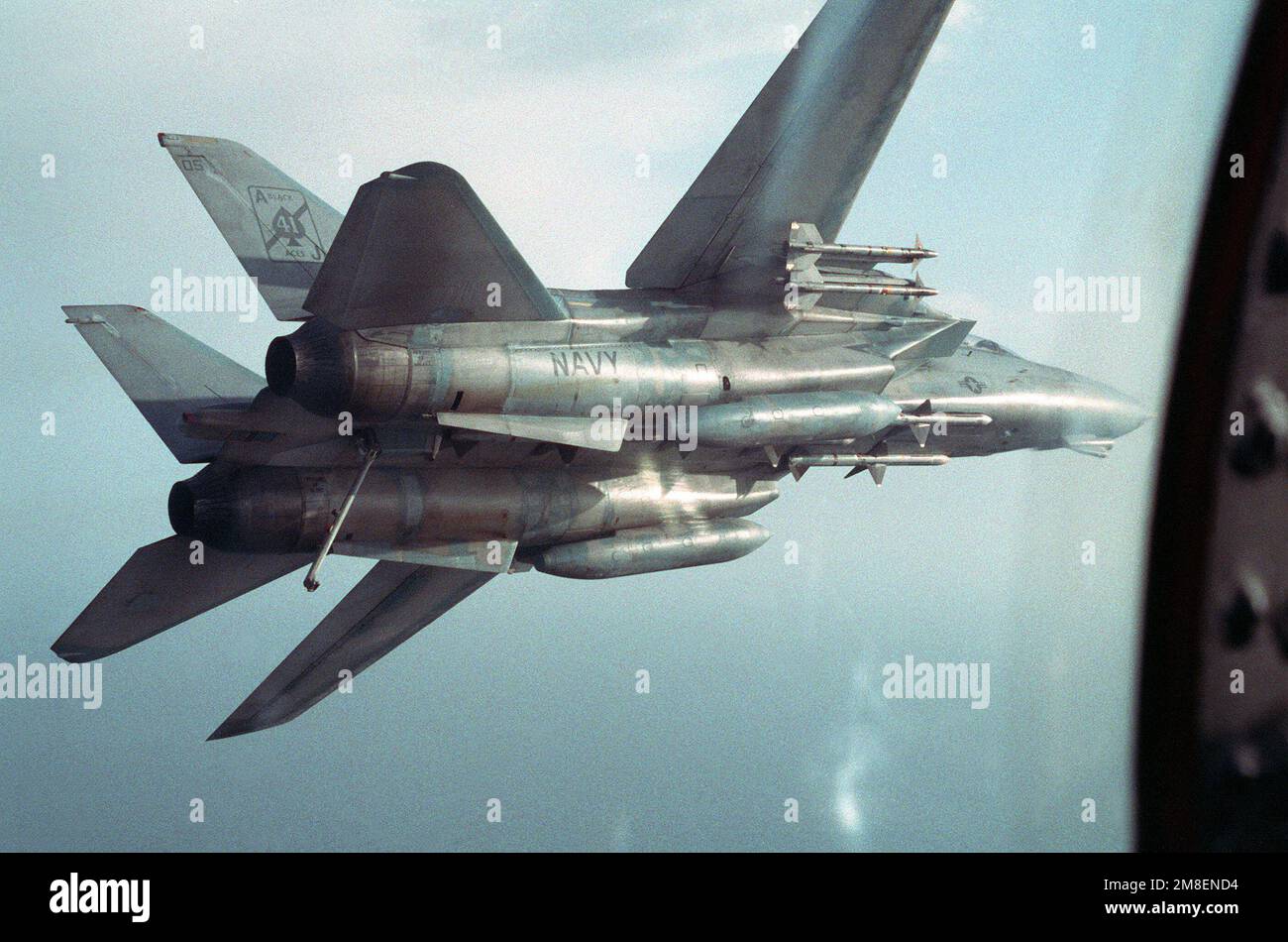 A Fighter Squadron 41 (VF-41) F-14A Tomcat aircraft banks into a turn ...